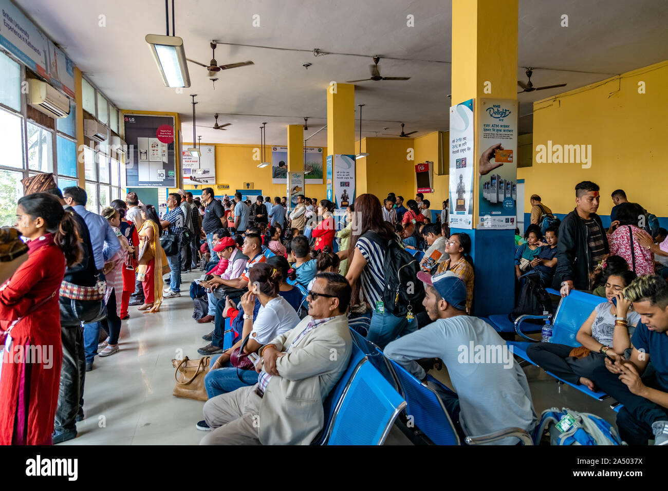 People waiting at airport terminal Stock Photo - Alamy