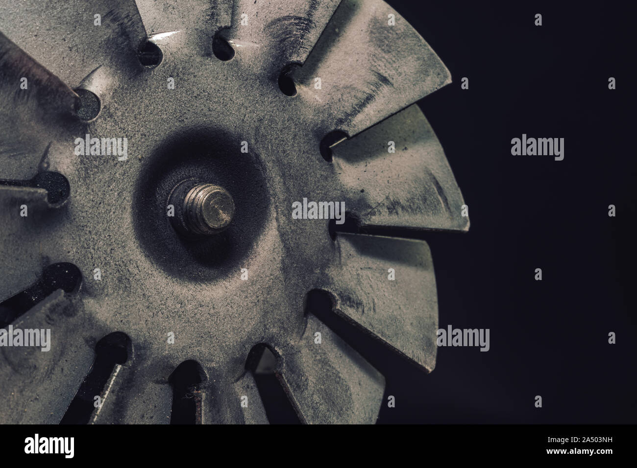 Close up old electric motor impeller on a dark background. Macro view ...