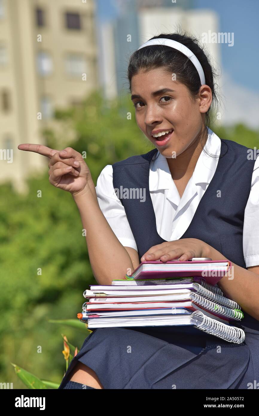 Girl Student Pointing Wearing Uniform With Notebooks Stock Photo - Alamy