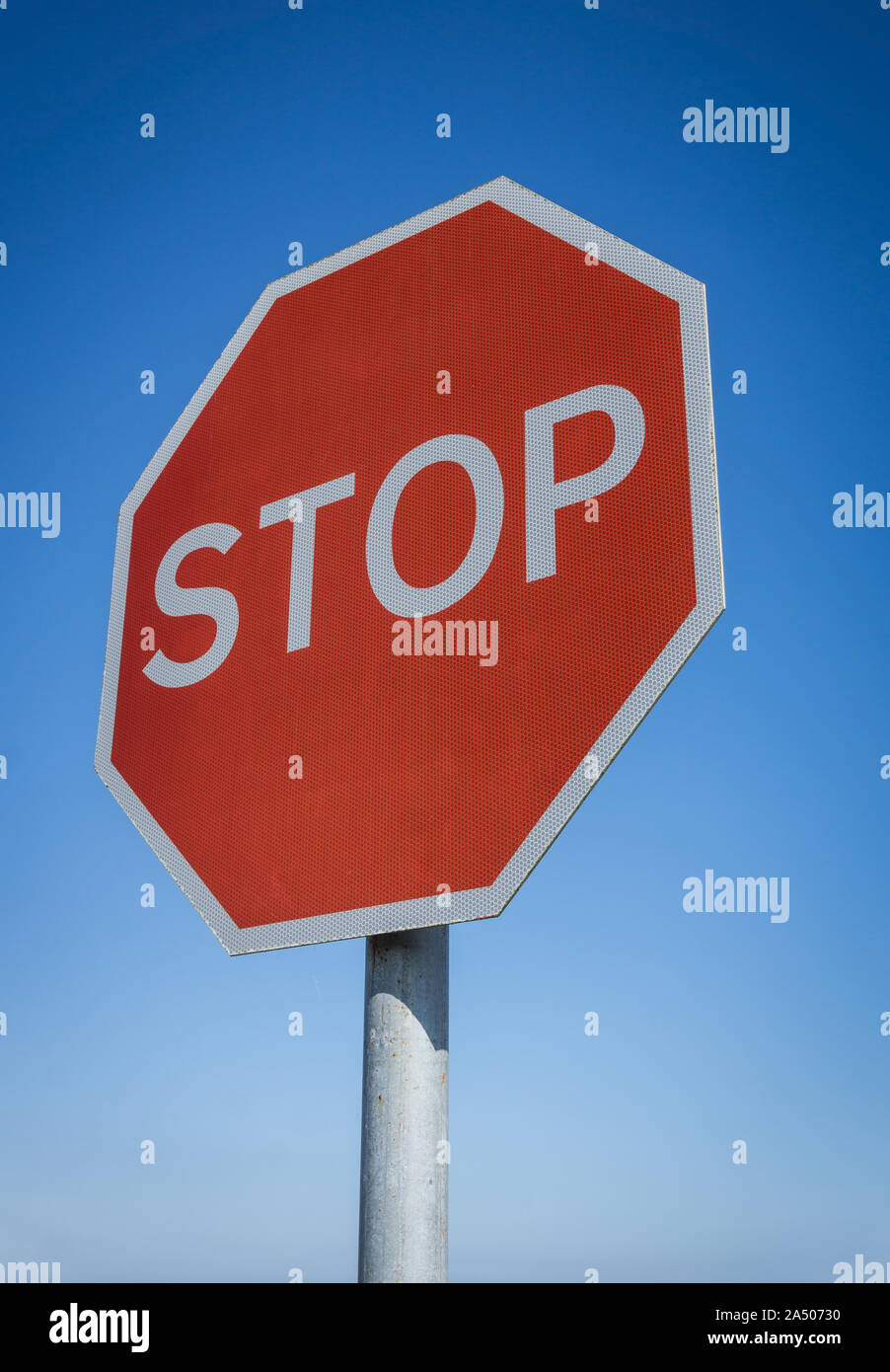 British stop sign against a clear blue sky Stock Photo - Alamy