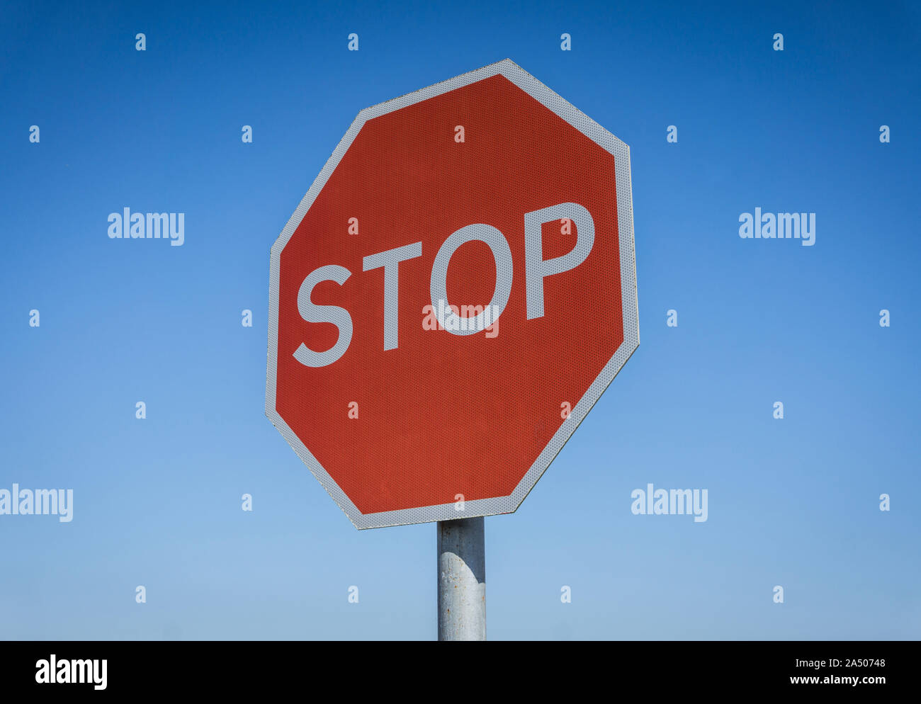 British stop sign against a clear blue sky Stock Photo - Alamy