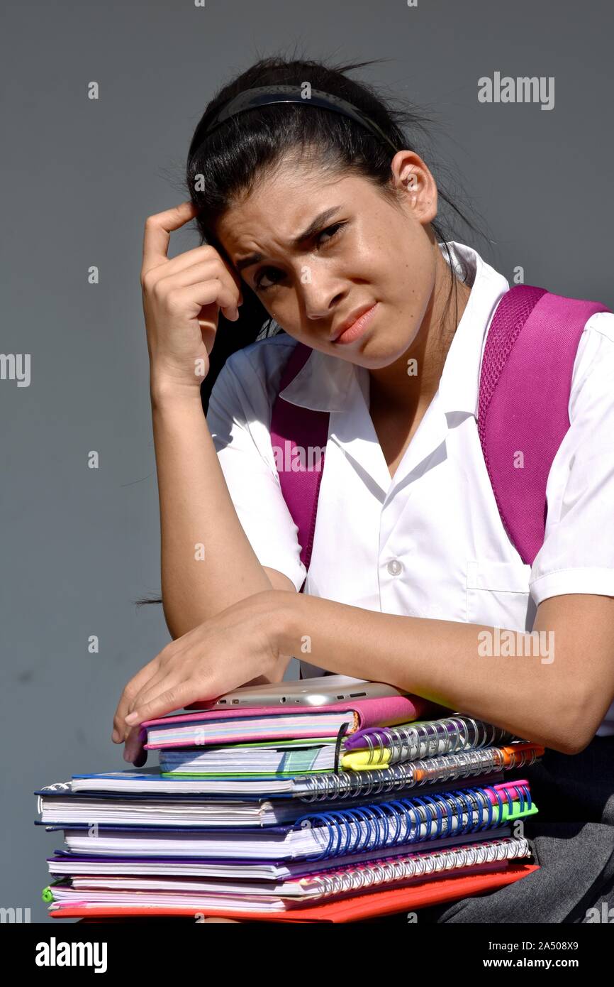 Cute Female Student And Confusion With Books Stock Photo - Alamy