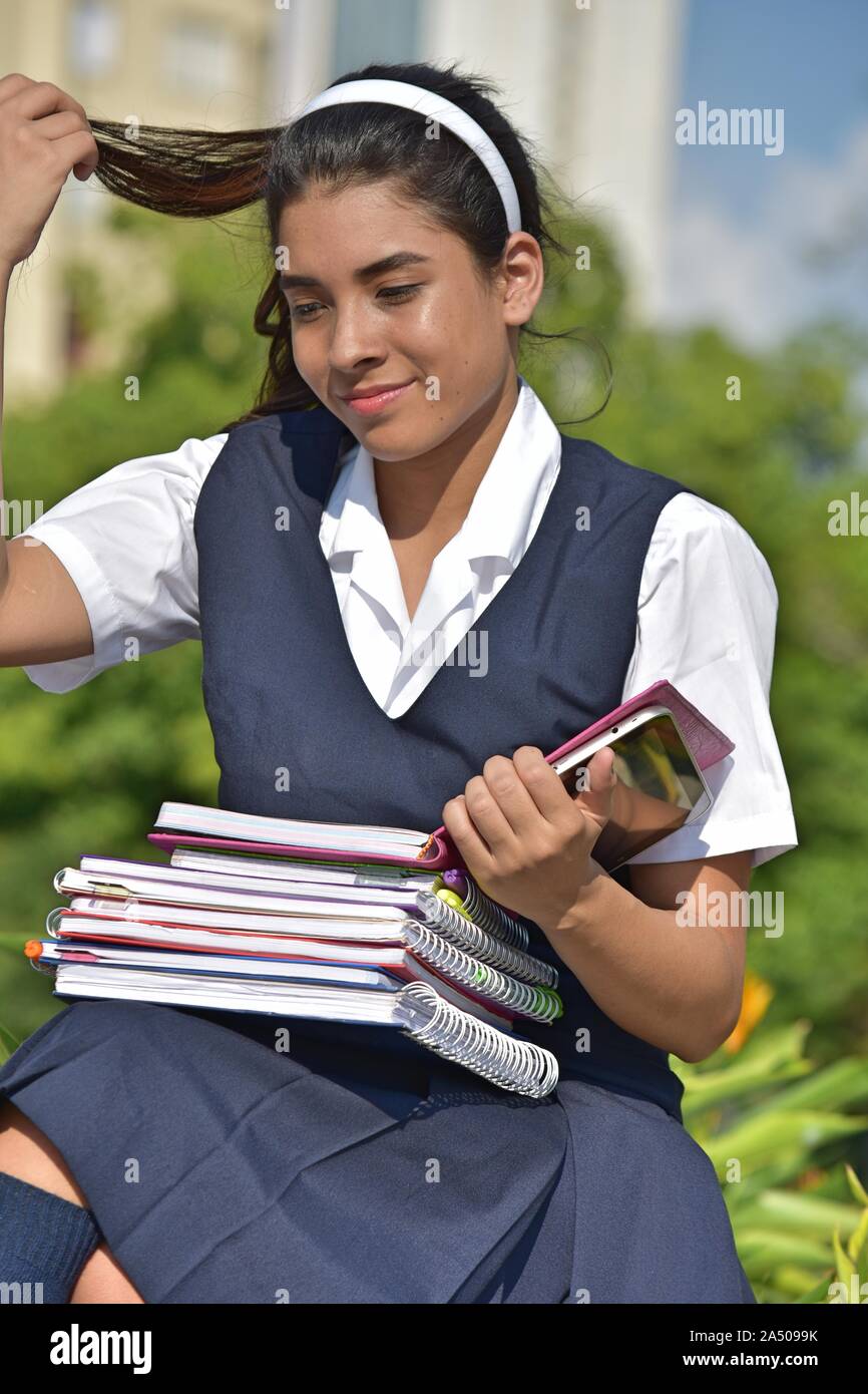 Female Student Reading Wearing School Uniform With Notebooks Stock ...