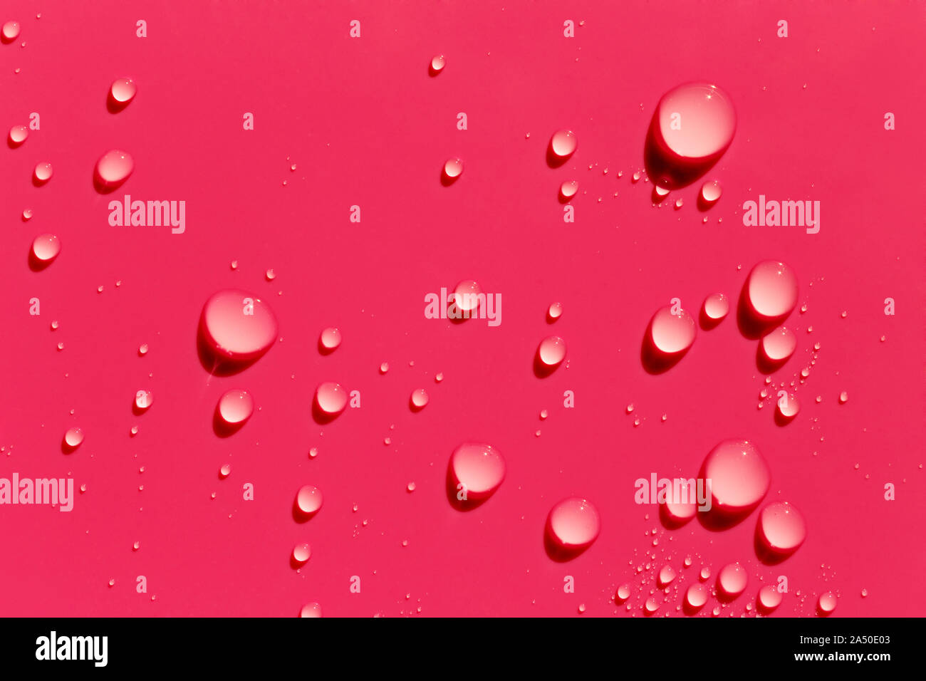 Macro image of water drops on red surface Stock Photo - Alamy