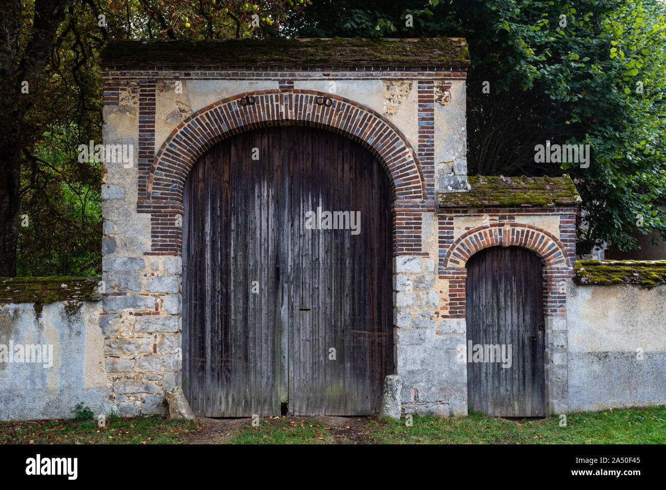 Large and small castle doors entrance in rural France Stock Photo - Alamy