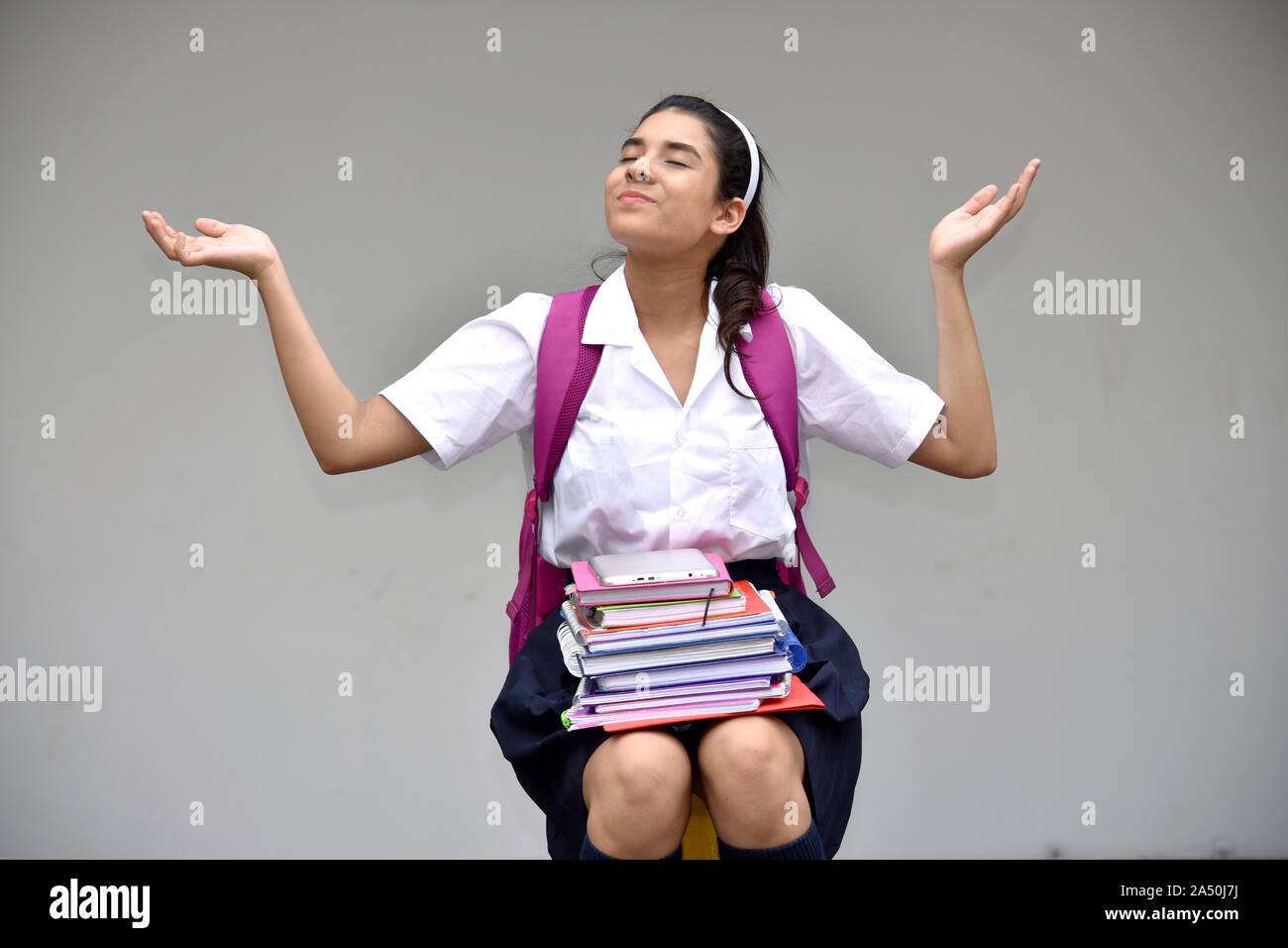 Female Student Wondering With Notebooks Stock Photo - Alamy