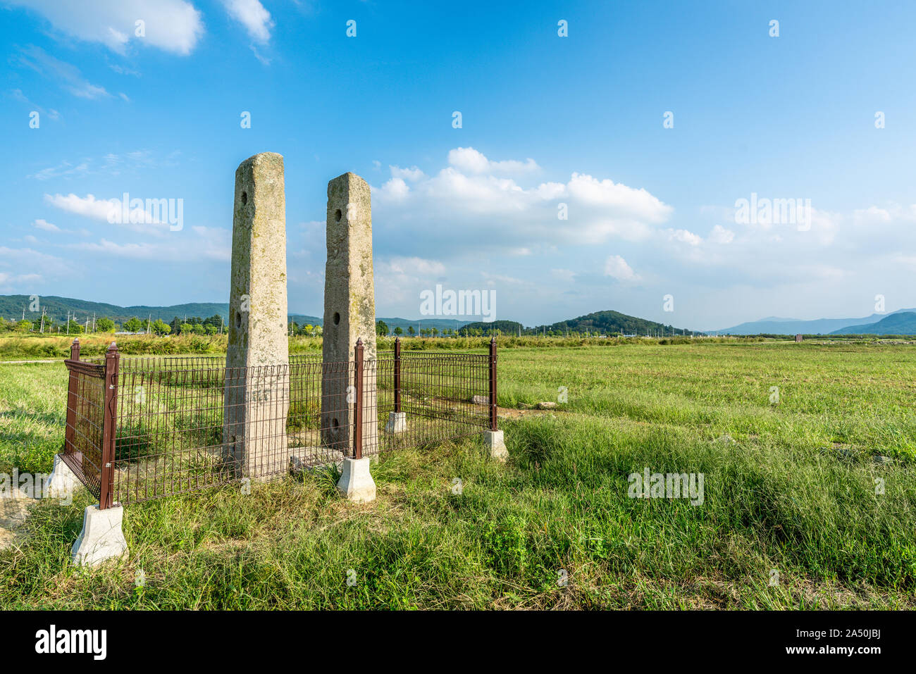 Ancient stone flagpole support called Dangganjiju with blue sky at ...