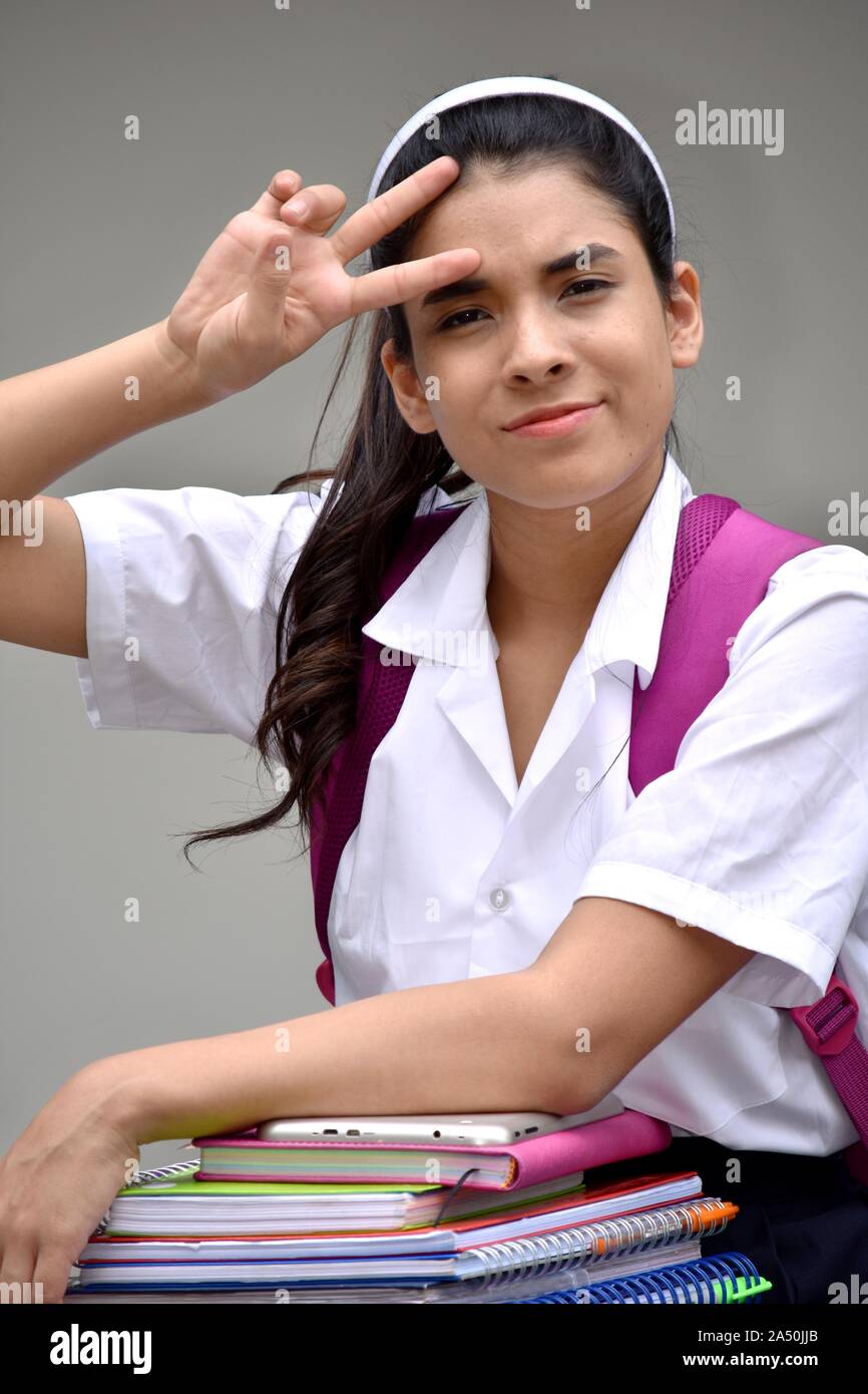 Cute School Girl And Peace Sign Stock Photo - Alamy