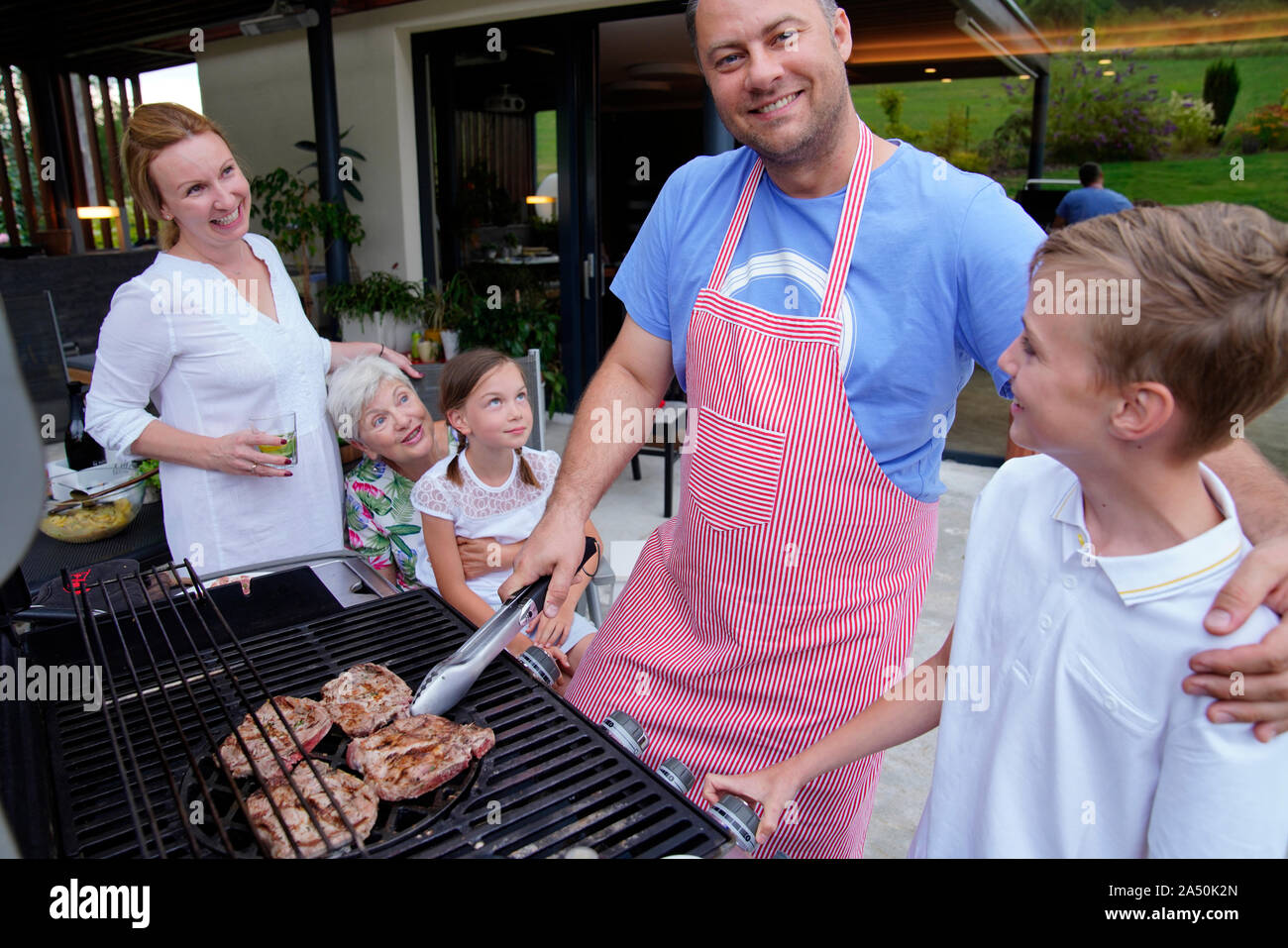 Family at the barbecue Stock Photo - Alamy