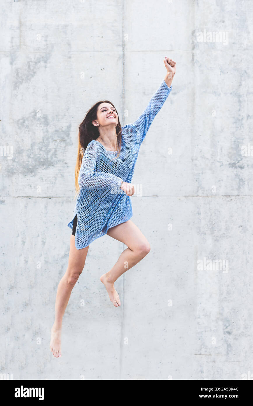 Portrait of a beautiful young woman jumping Stock Photo - Alamy
