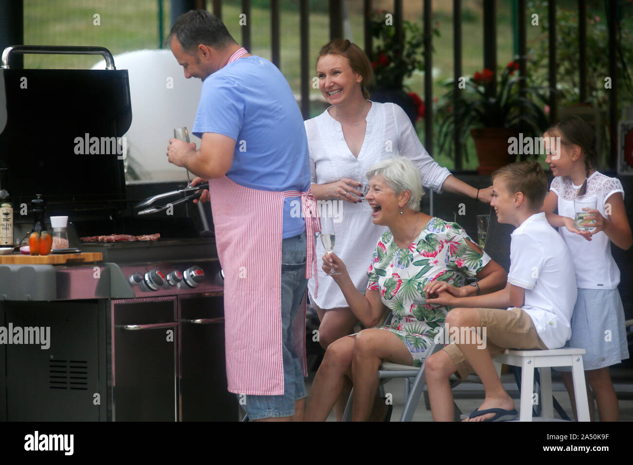 Family at the barbecue Stock Photo - Alamy