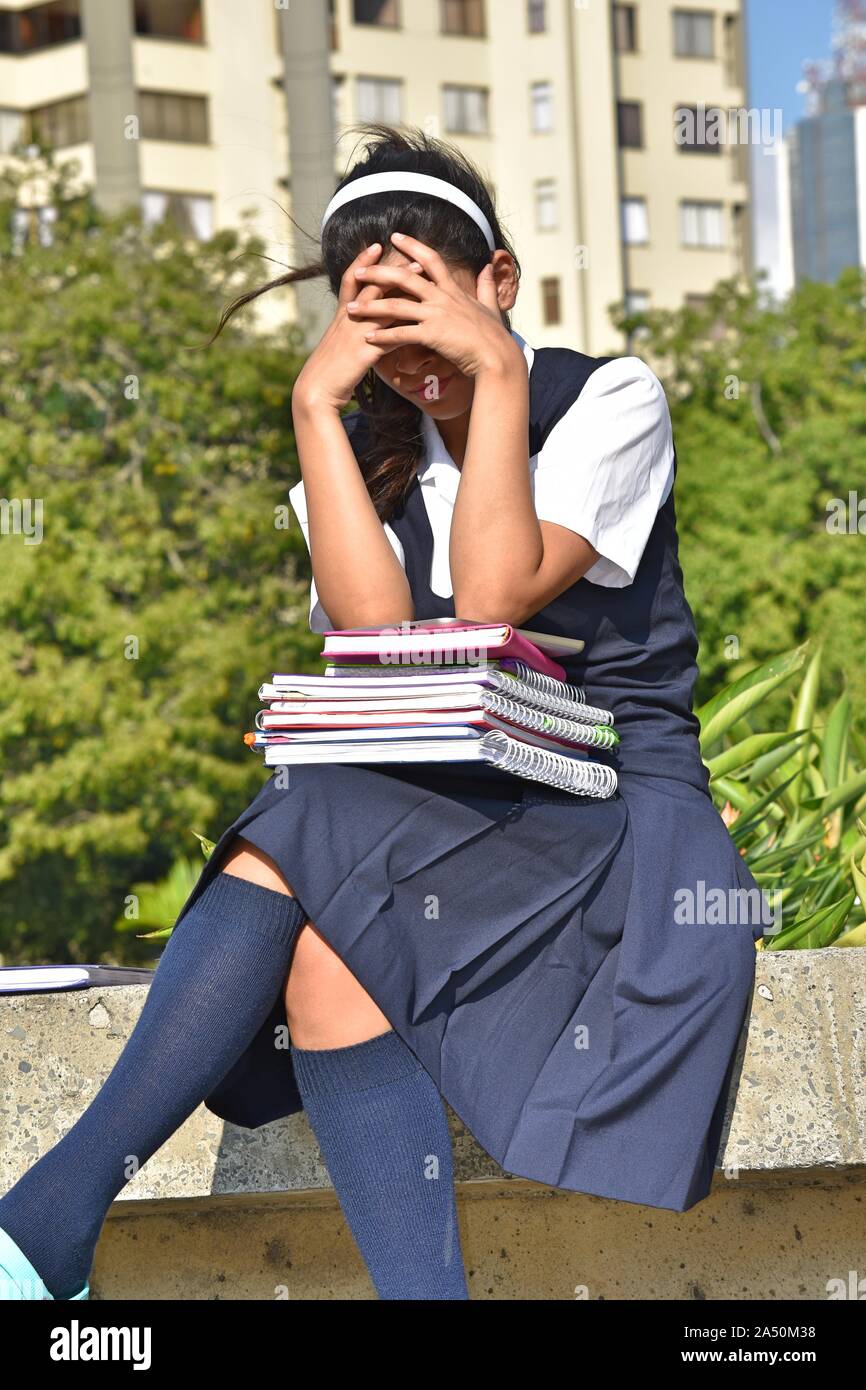 An Unhappy School Girl With Notebooks Stock Photo - Alamy