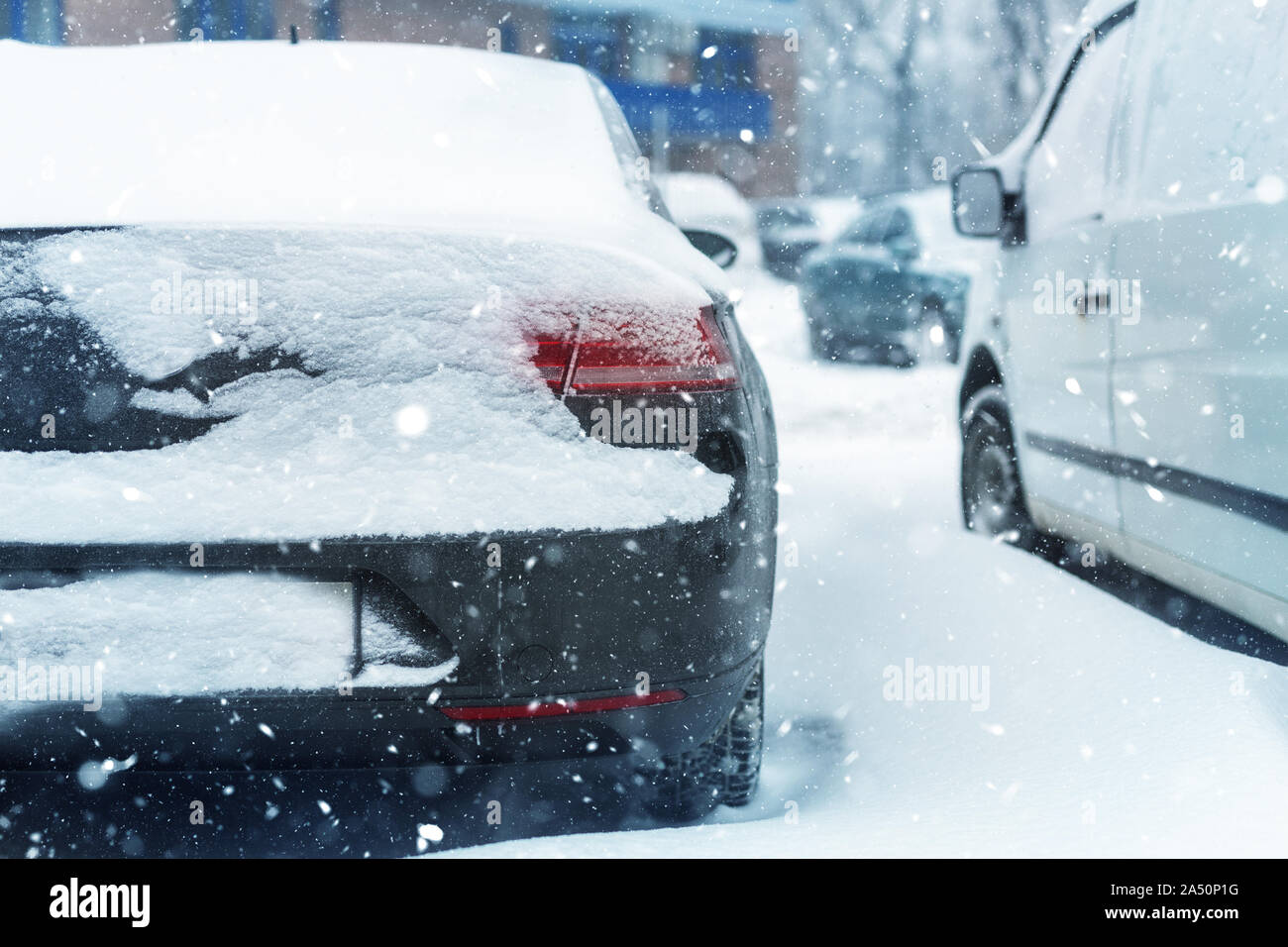 Car parked on city street covered with thick snow layer during ...