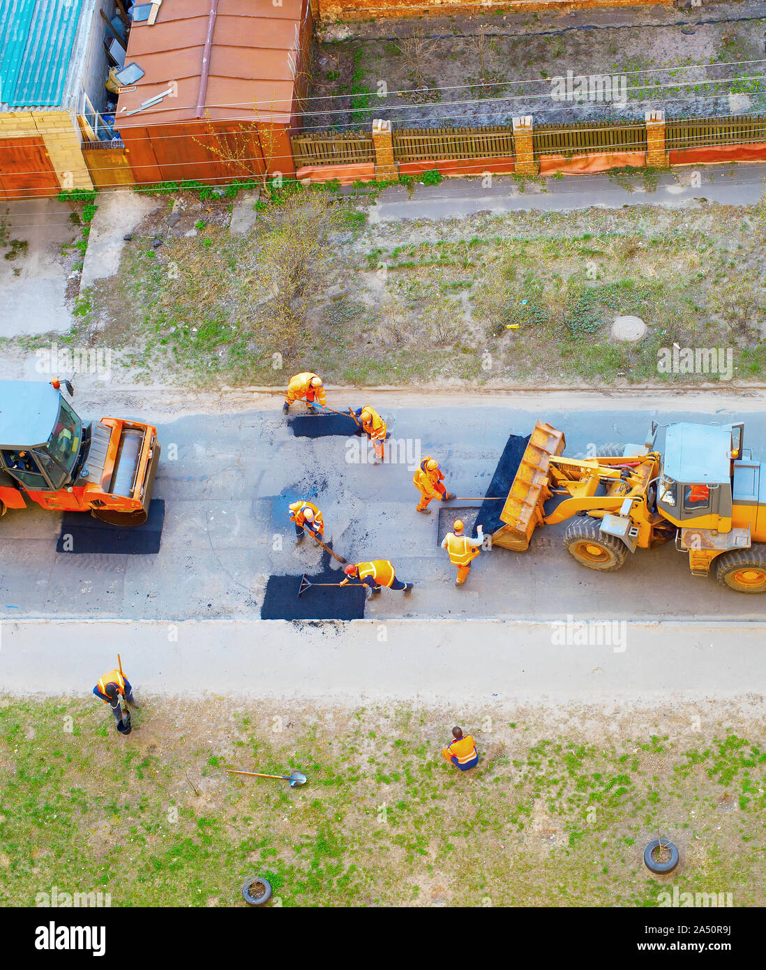 Workers, excavator, roller compactor repair road, top view, Kiev ...