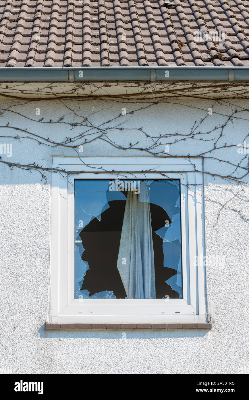 window with cracked glass after stone throw vandalism Stock Photo - Alamy