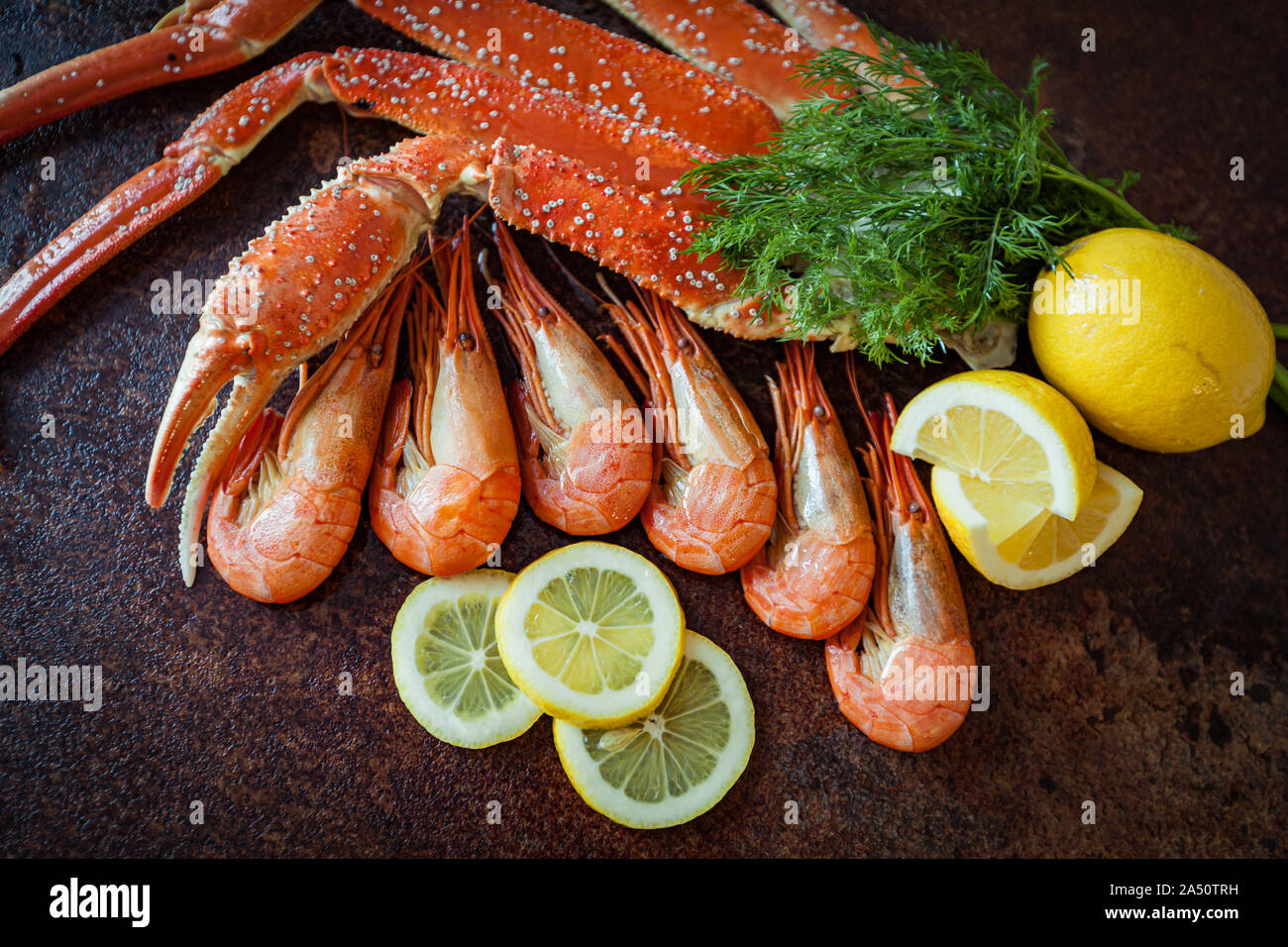 Crab legs on brown rustic background Stock Photo - Alamy