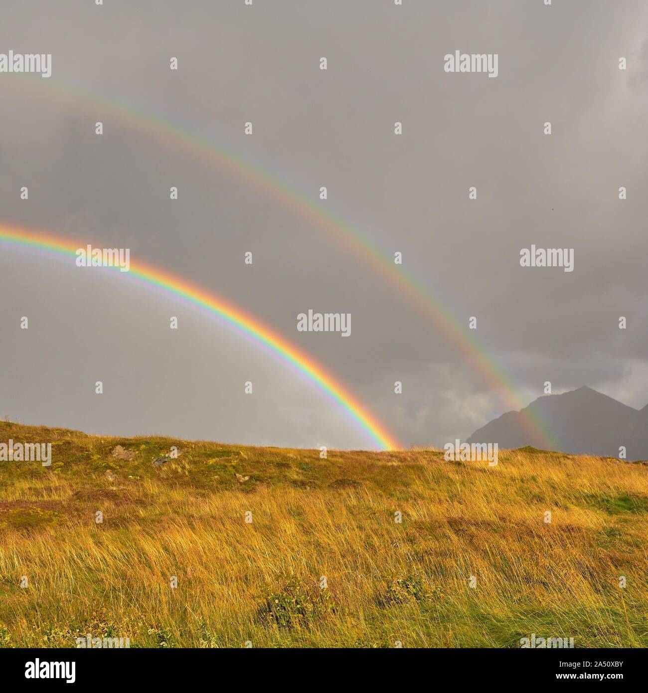 A beautiful double rainow. Rain clouds are spreading from far away ...