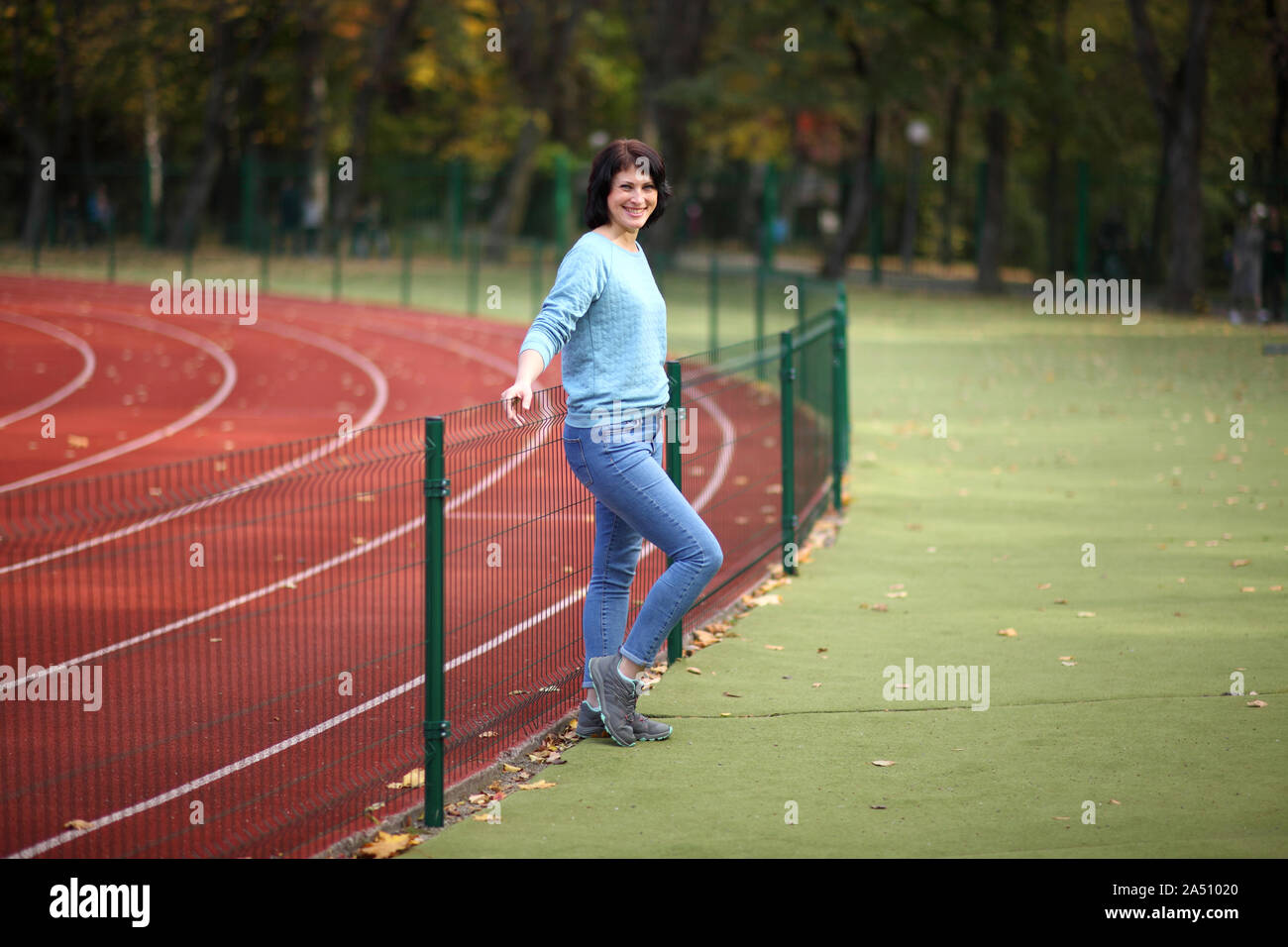 Beautiful woman in the stadium. Portrait of a fitness woman resting at ...