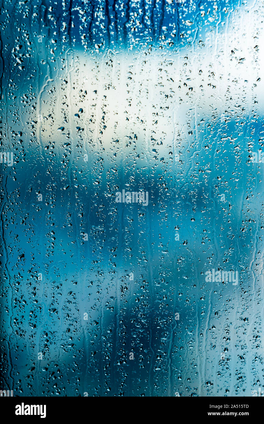 heavy rain drops on blue window Stock Photo - Alamy
