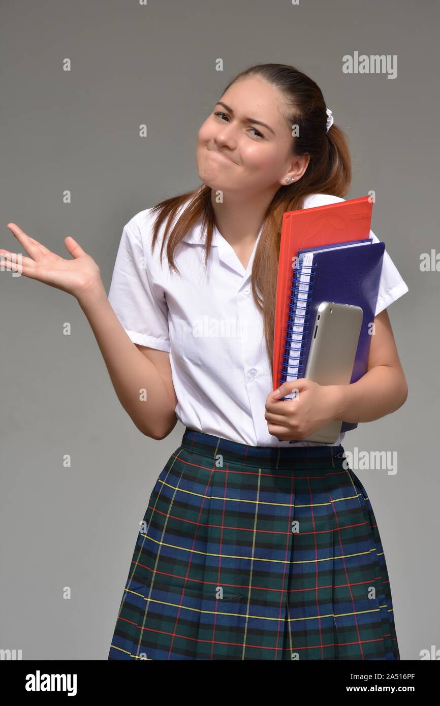 Indecisive Girl Student Wearing Uniform With Books Stock Photo - Alamy