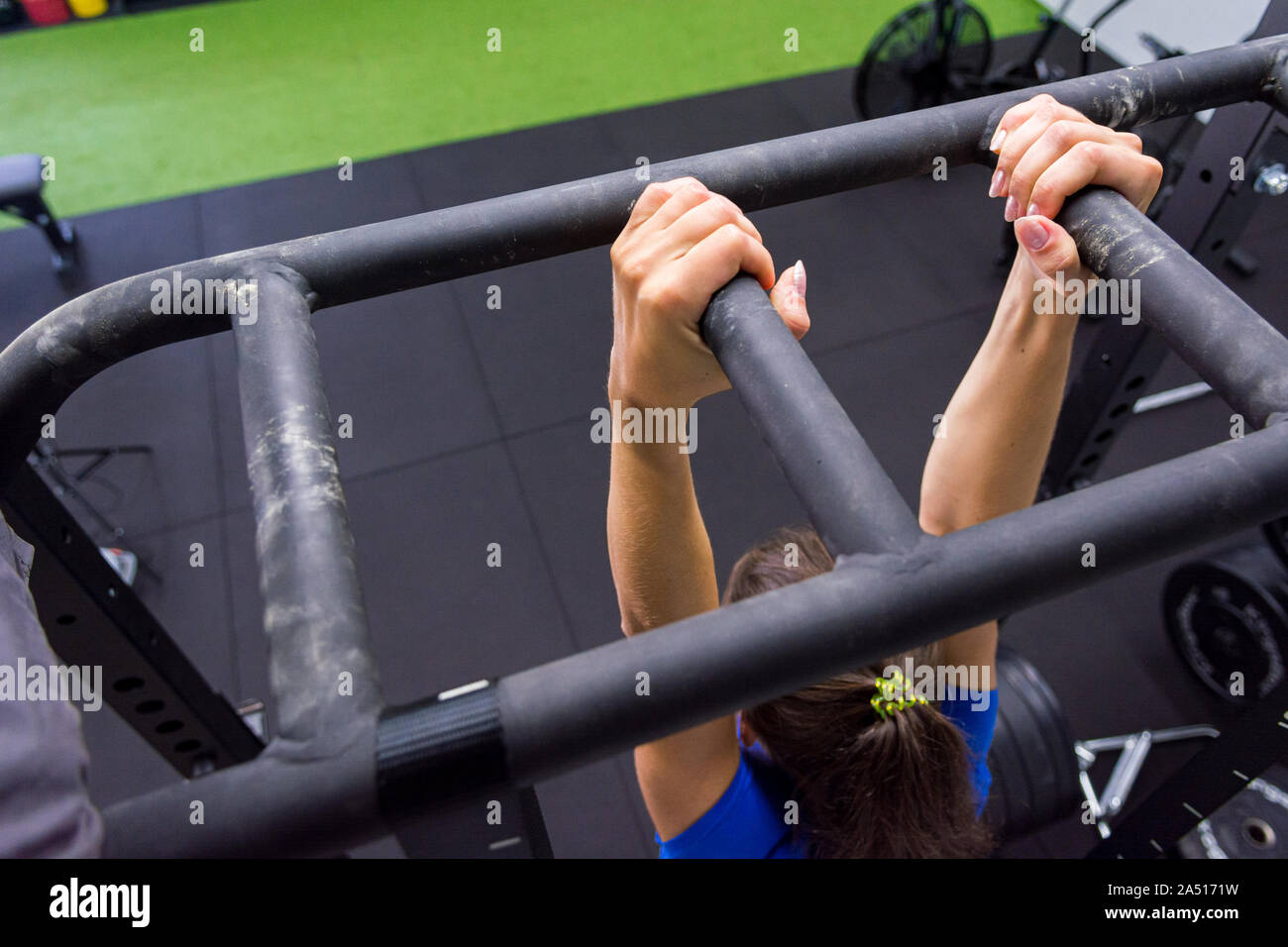 Detail of female hands gripping bar rig and doing leg raises in local ...