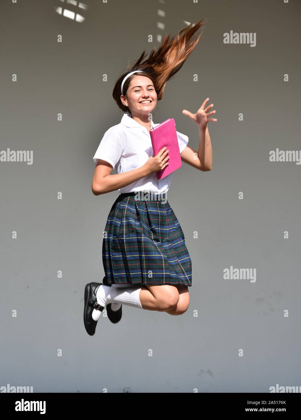 Happy Excited Girl Student Jumping Stock Photo - Alamy