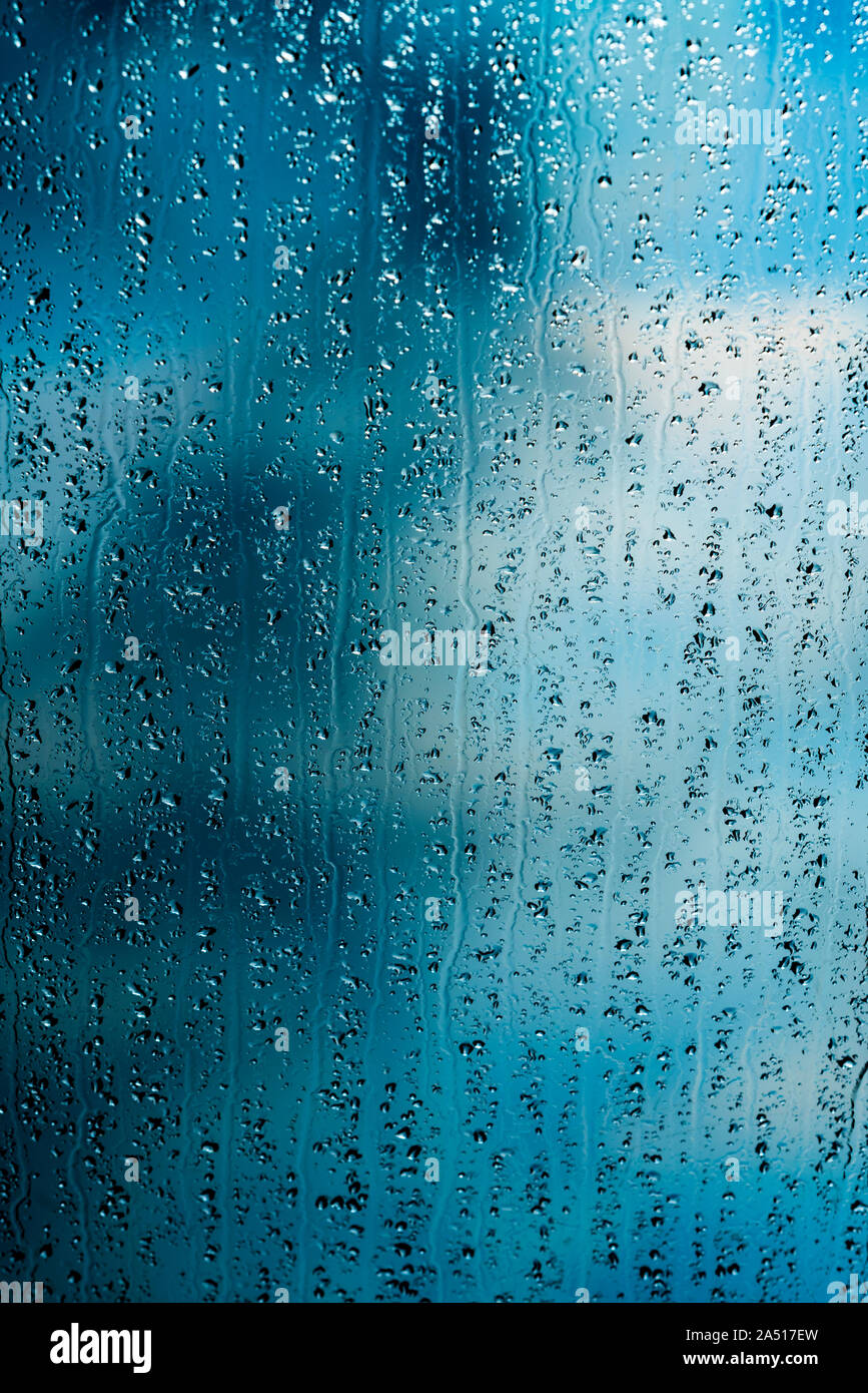 rain drops on window blue background Stock Photo - Alamy