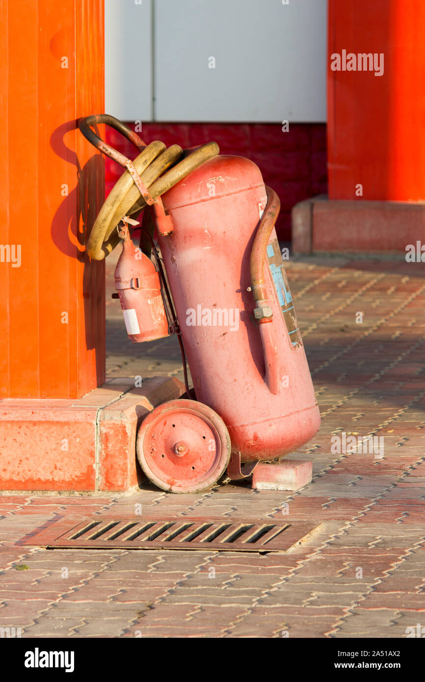 old red gas bottle and fire extinguisher at an abandoned gas station ...