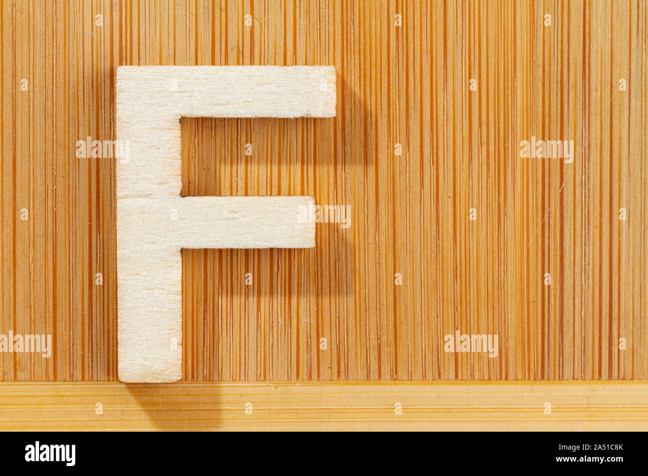 Letter F of wood-made alphabet, top view and space for text Stock Photo ...