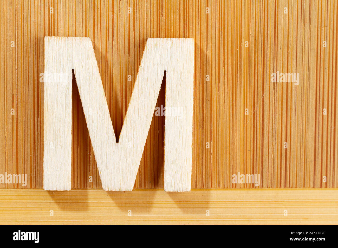 Letter M of wood-made alphabet, top view and space for text Stock Photo ...