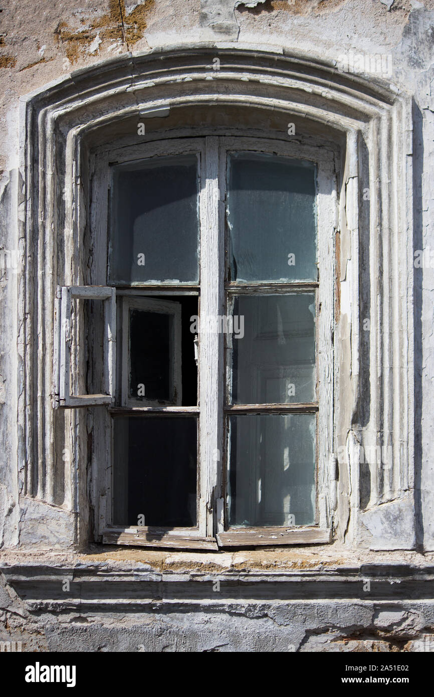 old wooden window with peeling paint in the village. vertical layout ...