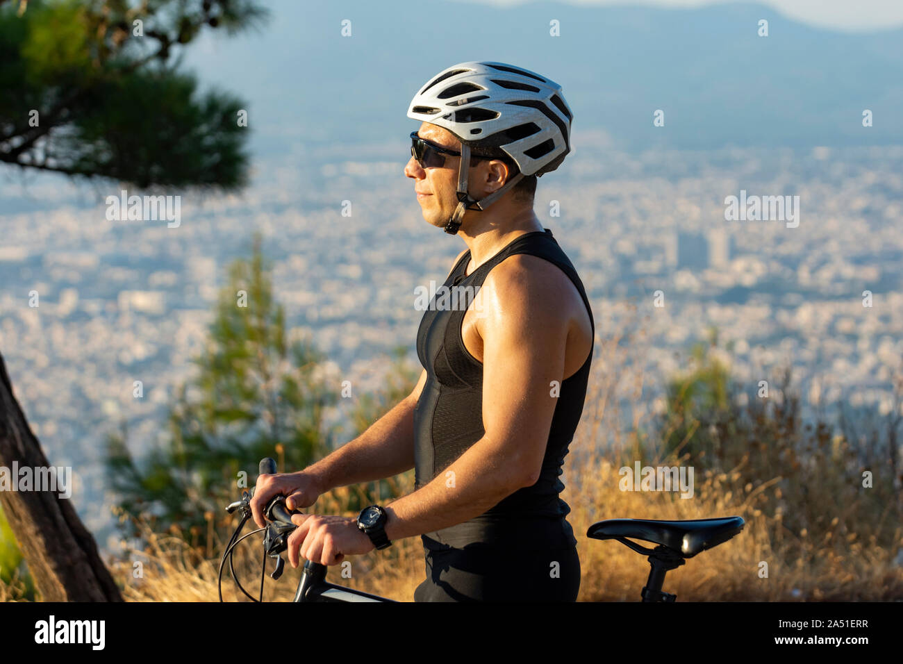 Male cyclist standing with his bike before or after training Stock ...