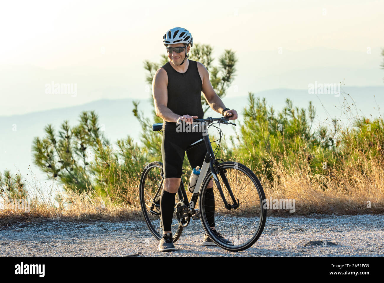 Male cyclist standing with his bike before or after training Stock ...