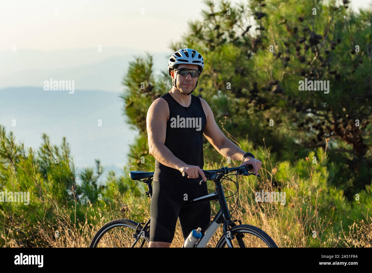 Male cyclist standing with his bike before or after training Stock ...