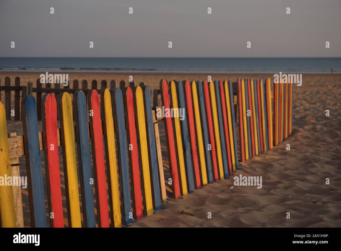 colorful wooden fence on the sandy beach Stock Photo - Alamy