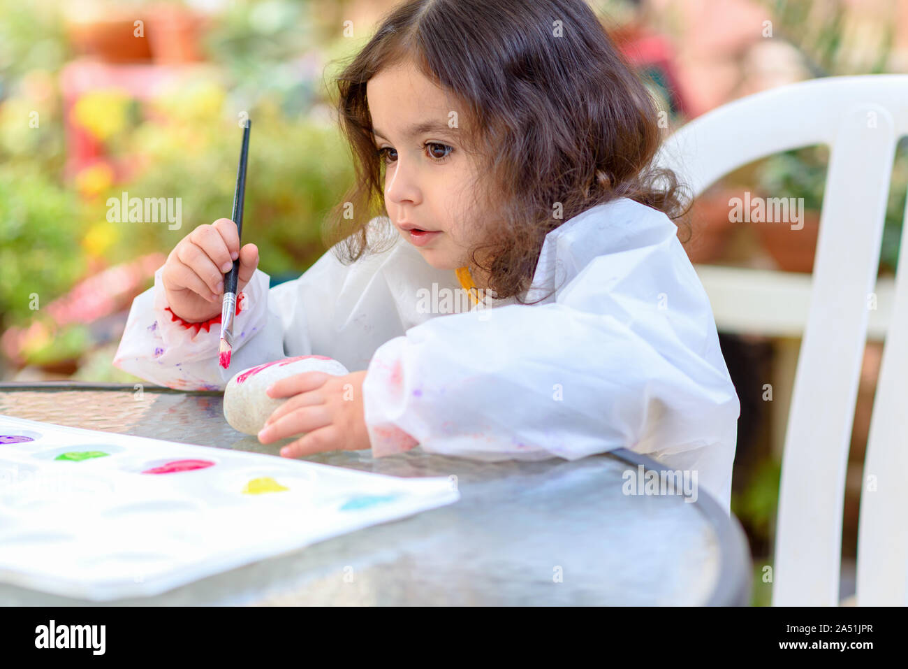 Portrait of little child painting, summer outdoor.Kid drawing on a ...