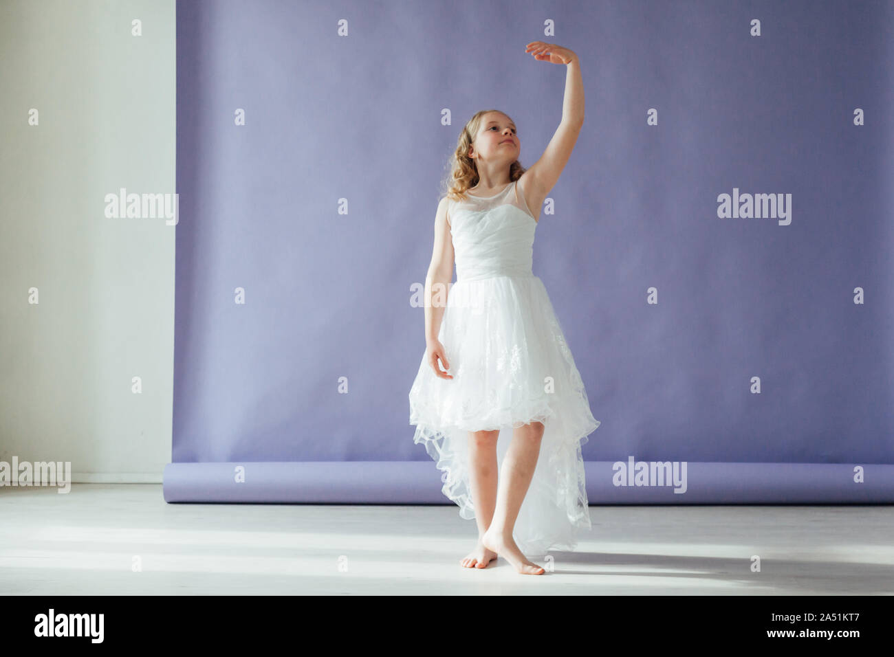 Beautiful blonde girl in dress dancing alone at home Stock Photo - Alamy