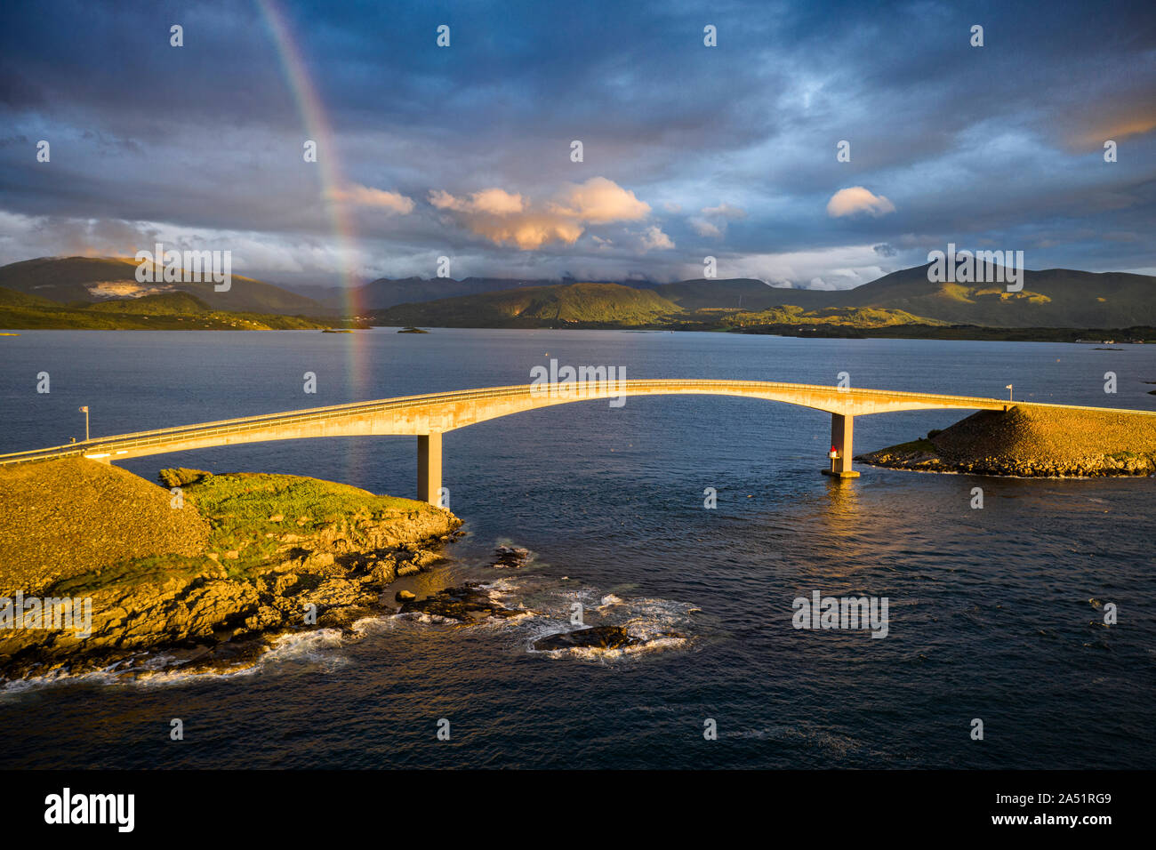 Aerial view of rainbow over Storseisundet Bridge at sunset, Atlantic ...