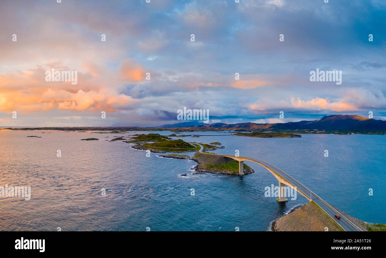 Car driving along Storseisundet Bridge at sunset, aerial view, More og ...