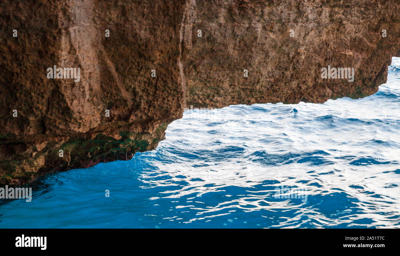 Blue Grotto, Malta. Abstract natural photo with red rocky cave wall and ...