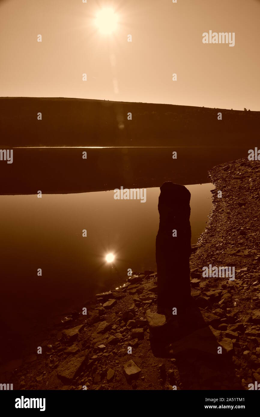 sepia sunrise reflected on a water mirror surface Stock Photo - Alamy