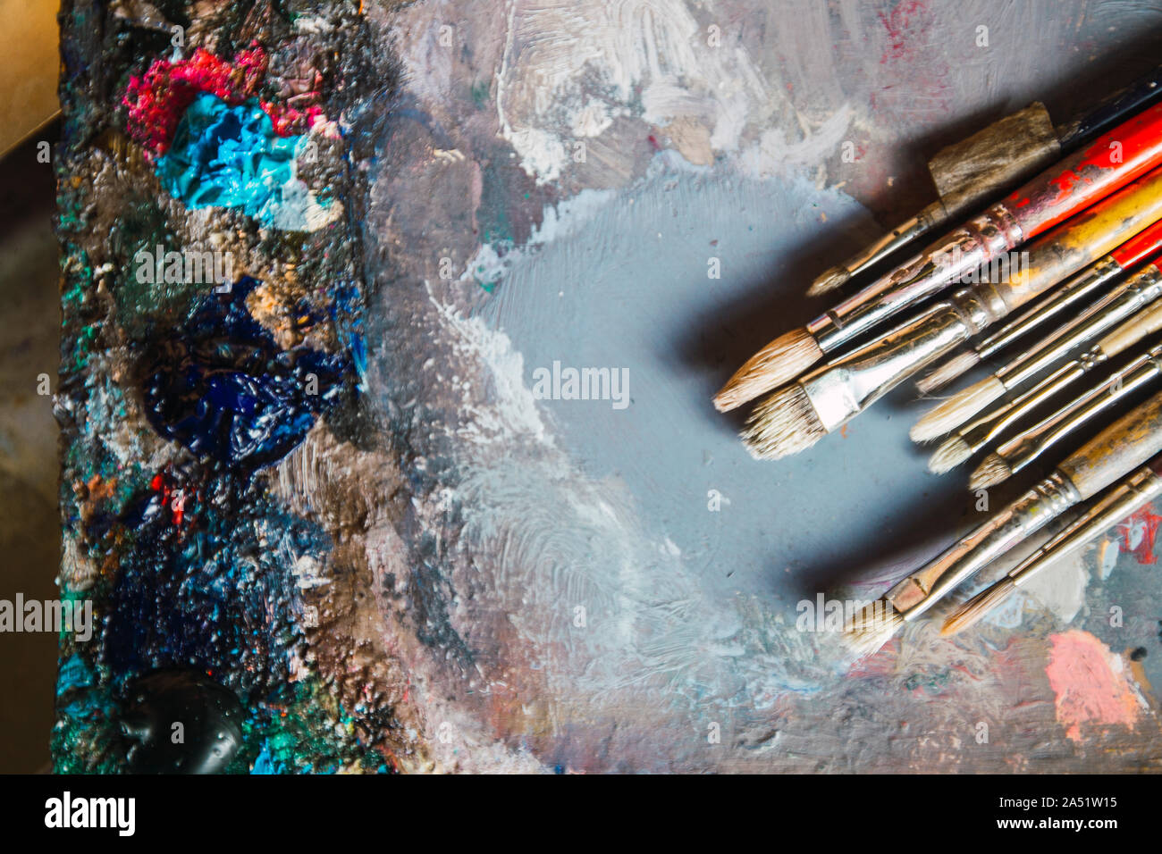 used and very stained color palette of various uses with various brush ...