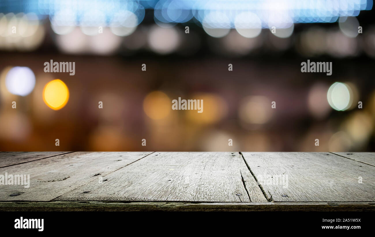 Empty wooden table platform and bokeh at night Stock Photo - Alamy