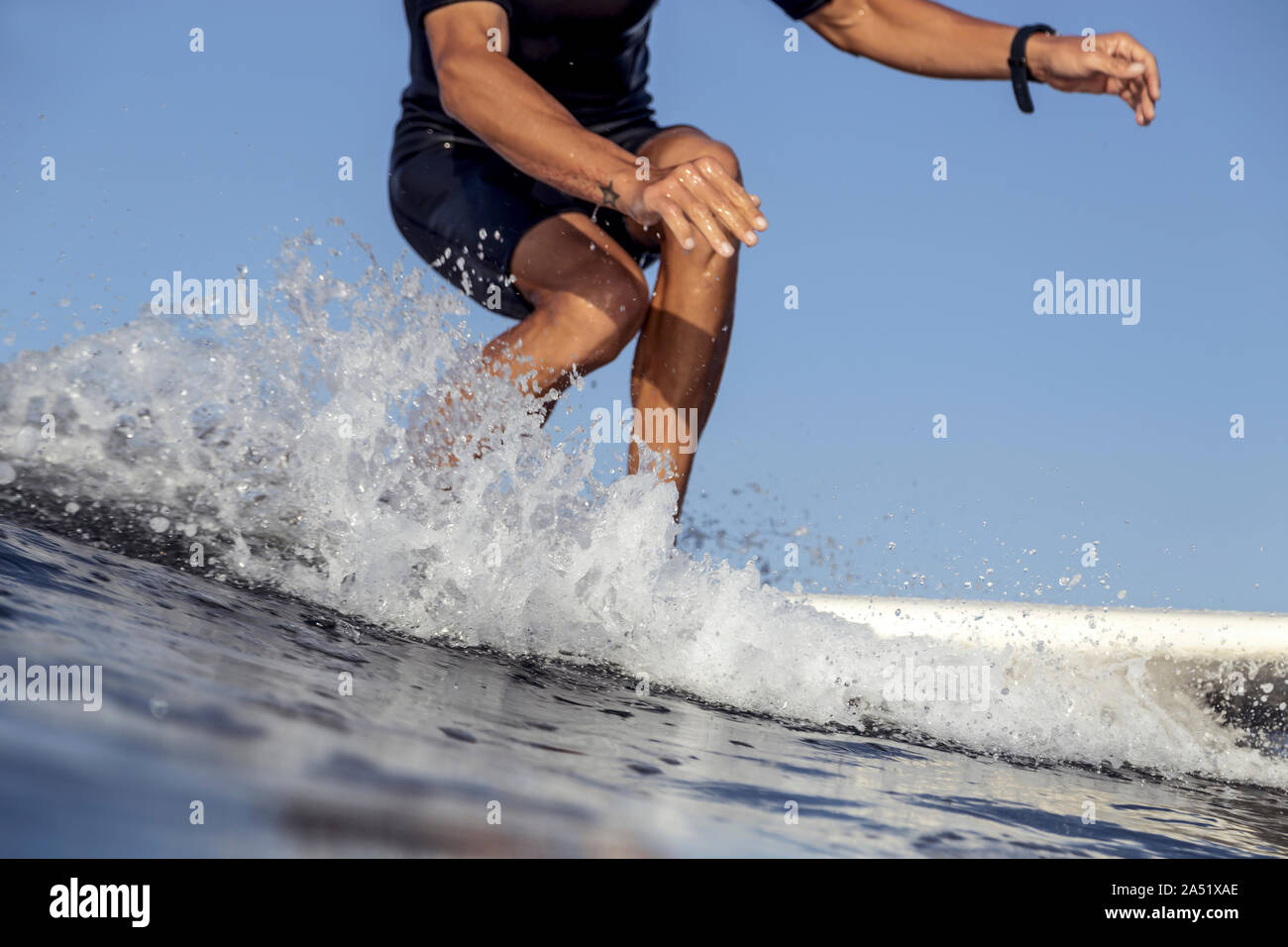 Legs of surfer on a wave Stock Photo - Alamy