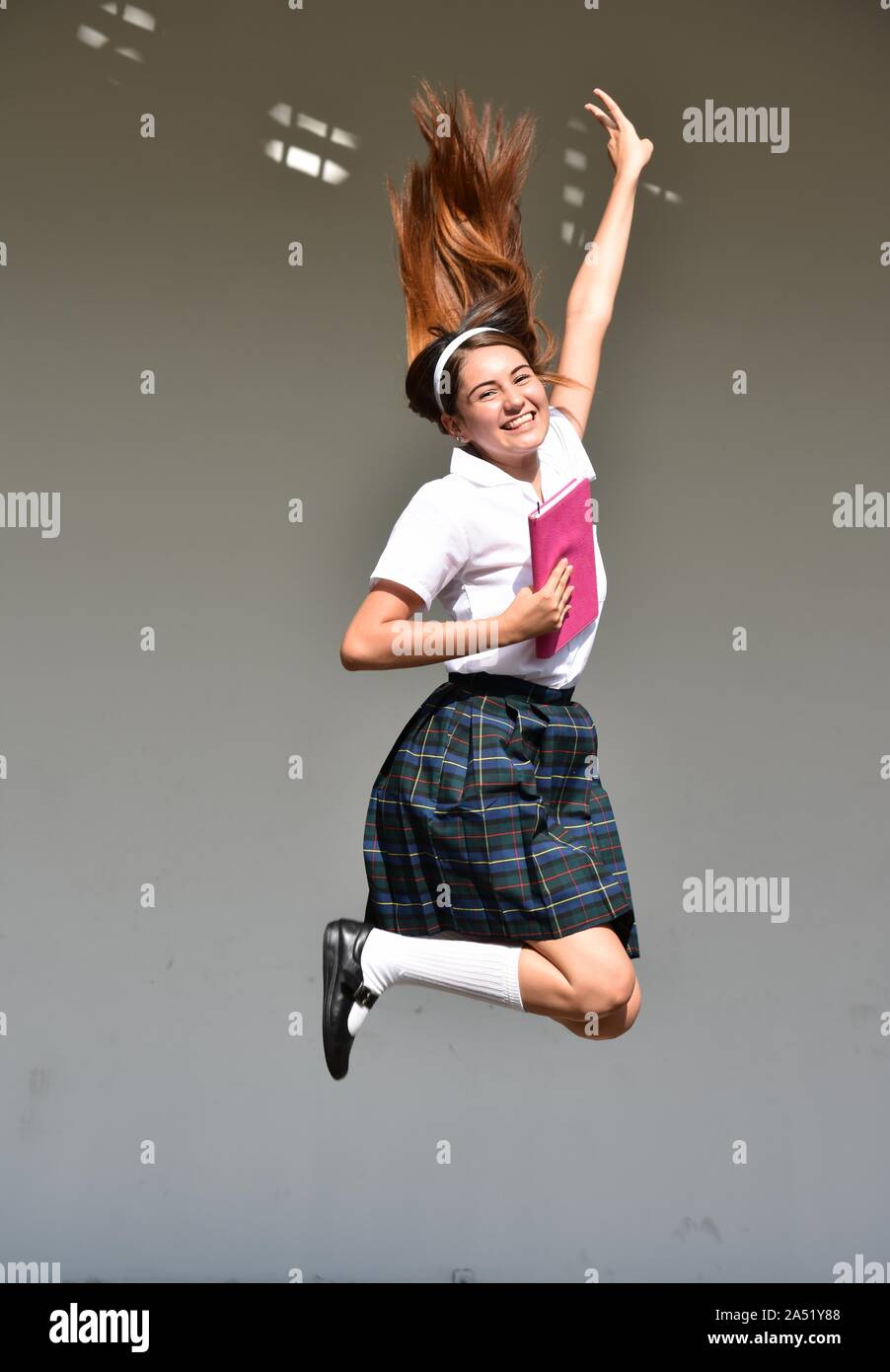 Happy Excited Girl Student Jumping Stock Photo - Alamy