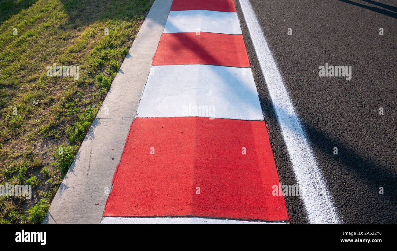 Motor racing circuit Red and White Kerb Stock Photo - Alamy