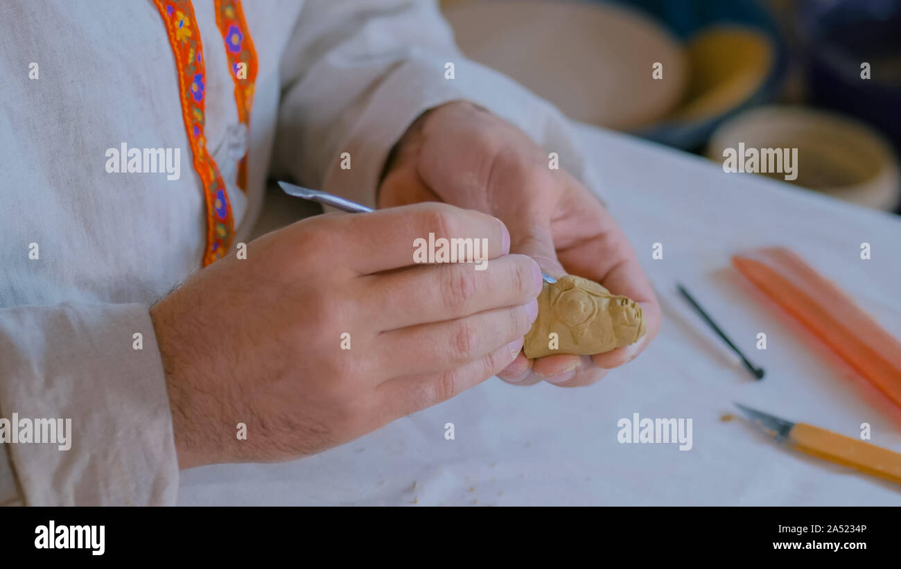 Potter making clay figure for board game Stock Photo - Alamy