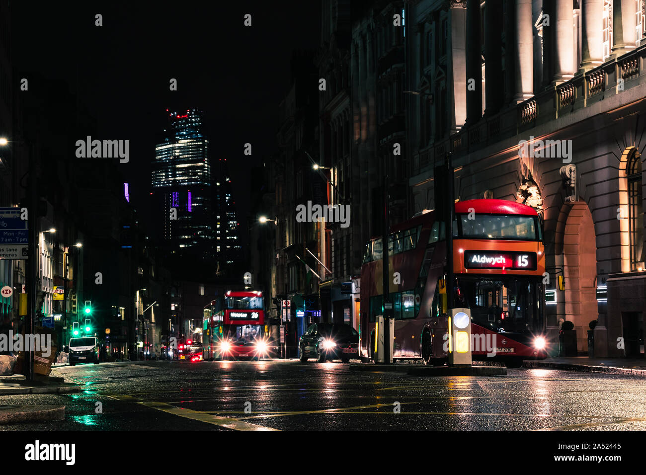 typical london buses commuting at night in central london with skyline ...