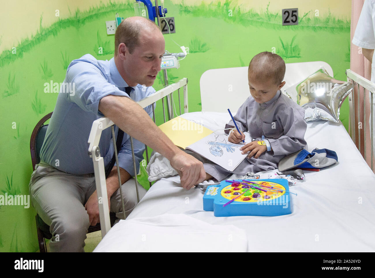 The Duke of Cambridge with cancer patient Muhammed Sameer, five, during ...