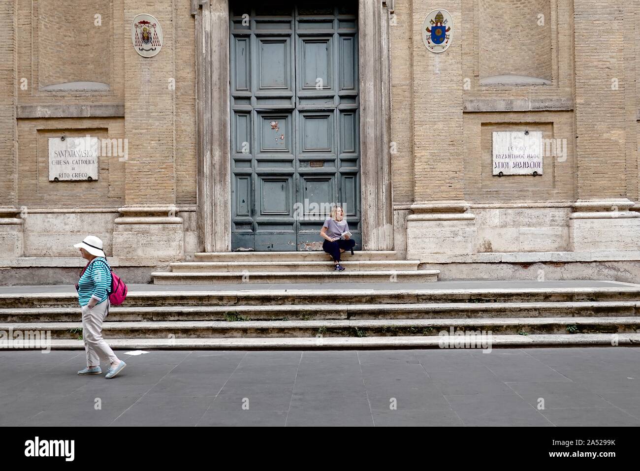 A tourist walks past The Catholic Church of the Greek Rite in Rome ...